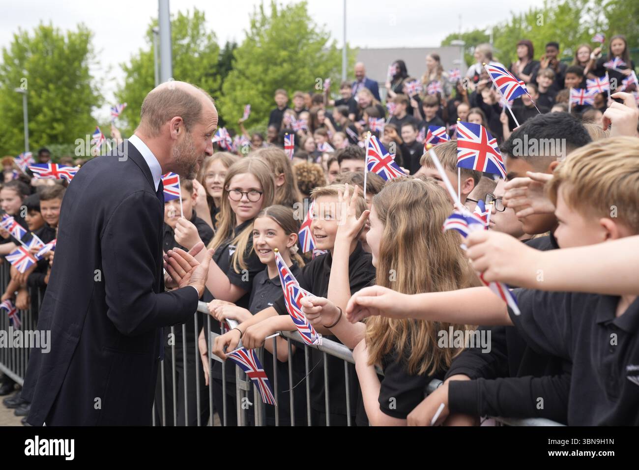 The Prince of Wales meets pupils during a visit to Meadowhead Secondary ...
