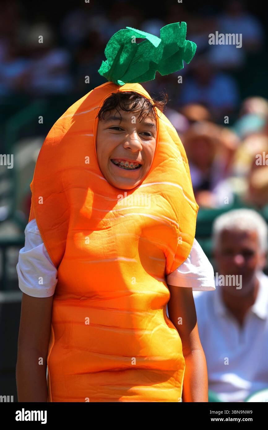 A tennis fan dressed as a carrot smiles at No1 Court ahead of the ...