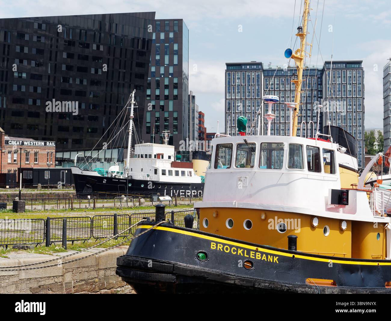 Ships/Vessels in a shipyard/dock with modern buildings behind in the ...