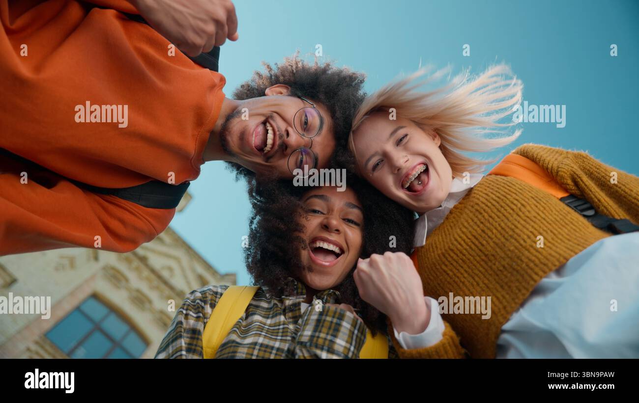 Bottom views three multiracial students together in city university ...