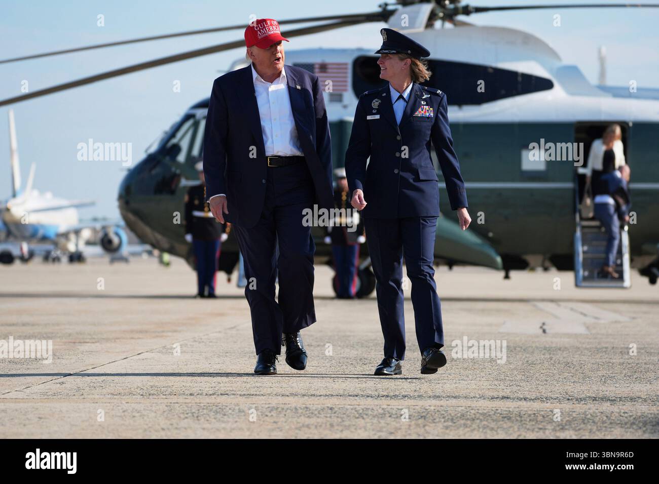 President Donald Trump, left, escorted by Air Force Col. Angela F ...