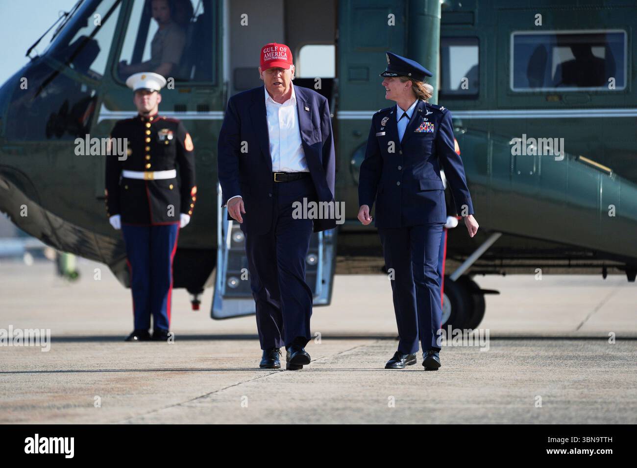 President Donald Trump, left, escorted by Air Force Col. Angela F ...