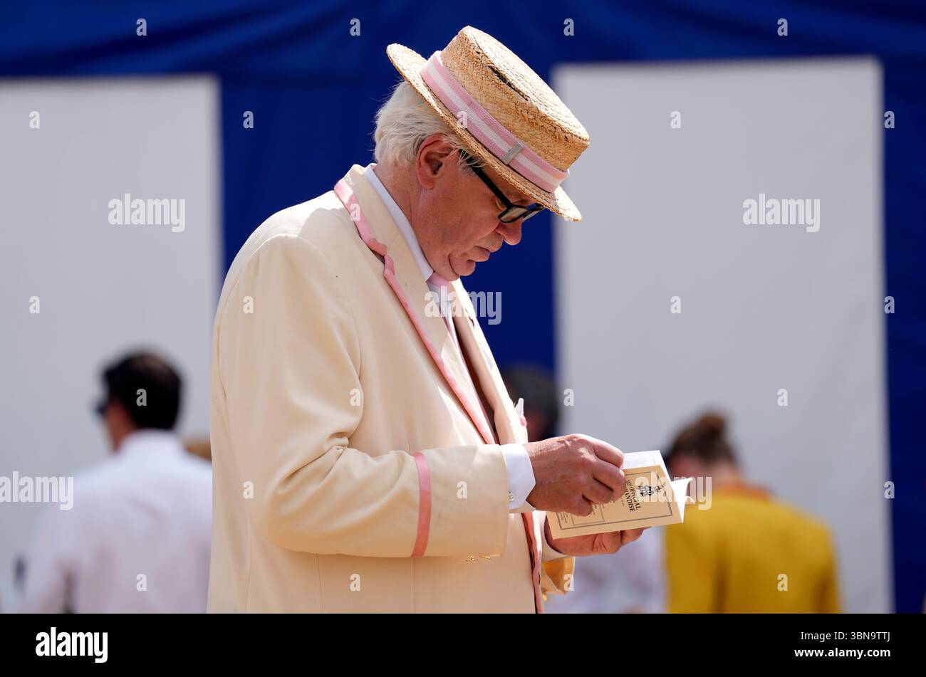 A person reads the race programme on the opening day of the 2025 Henley ...