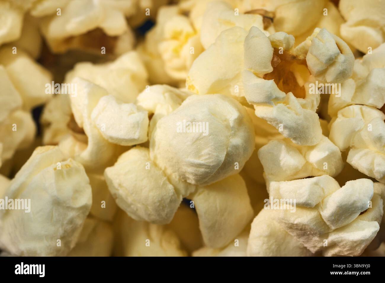 Freshly popped popcorn filling a bowl ready for movie night or a snack ...