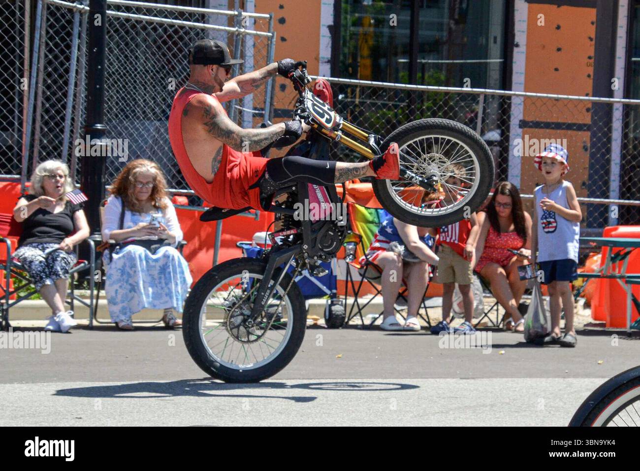 A cyclist with Cycle Paths Bicycle Club pops a wheelie during the ...