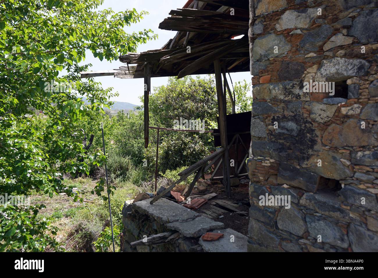 A partially collapsed stone structure, possibly a house or a small ...