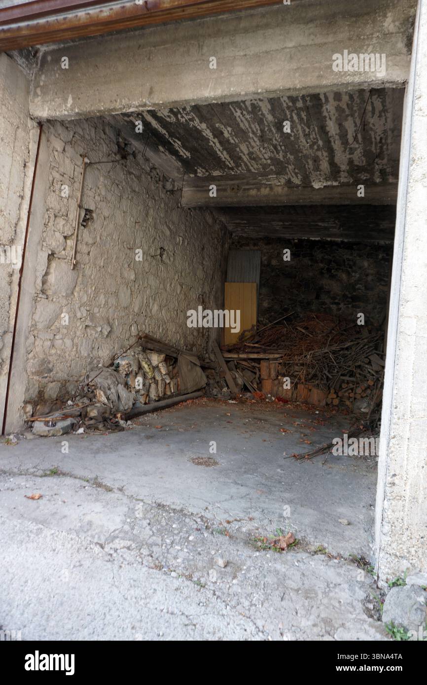 The interior of a dilapidated garage. The walls are constructed of ...