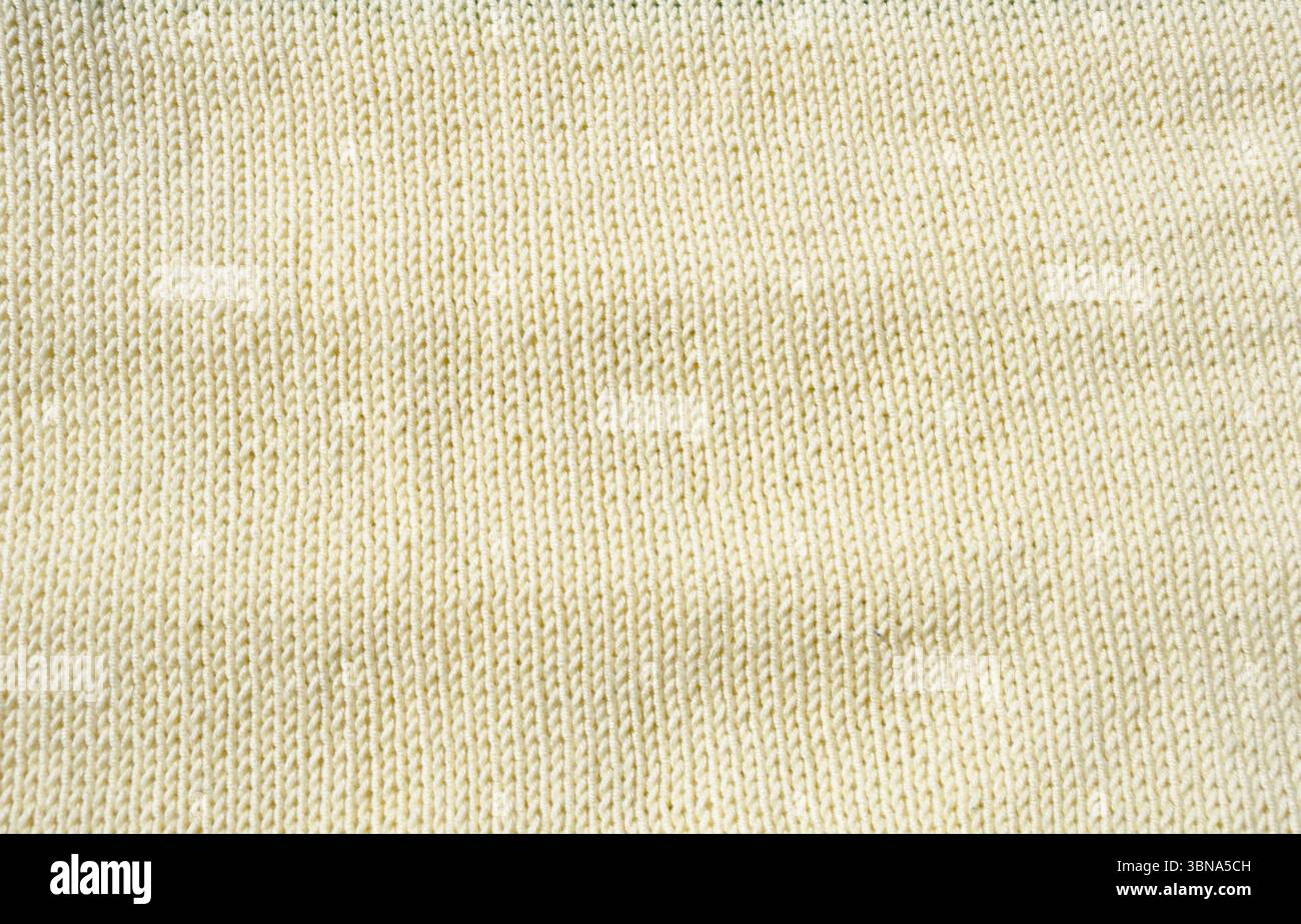 A detailed macro shot shows the milky fabric. The stockinette stitch ...