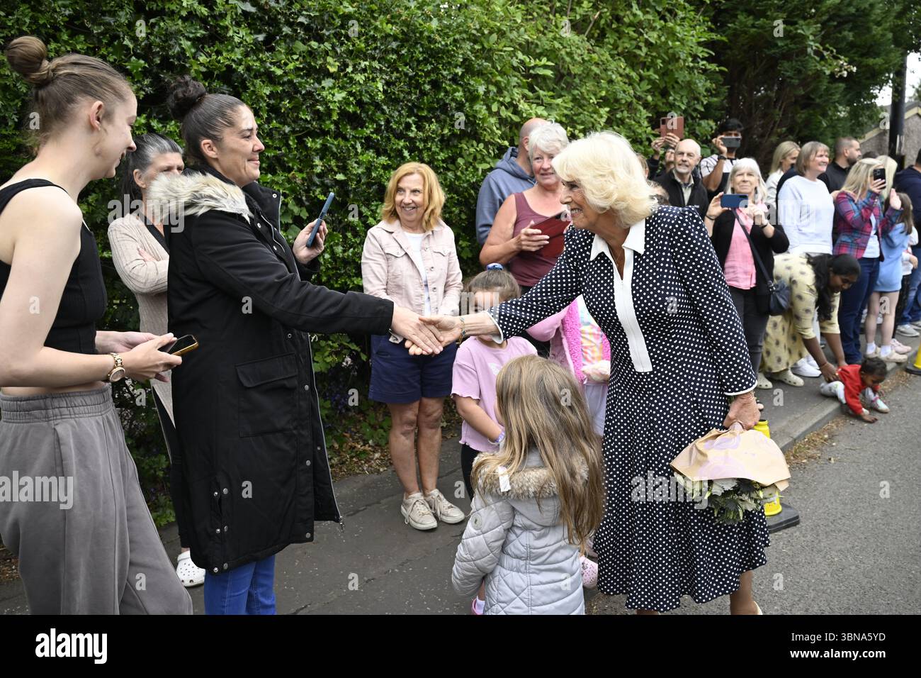 Queen Camilla meets members of the public as she leaves after opening ...