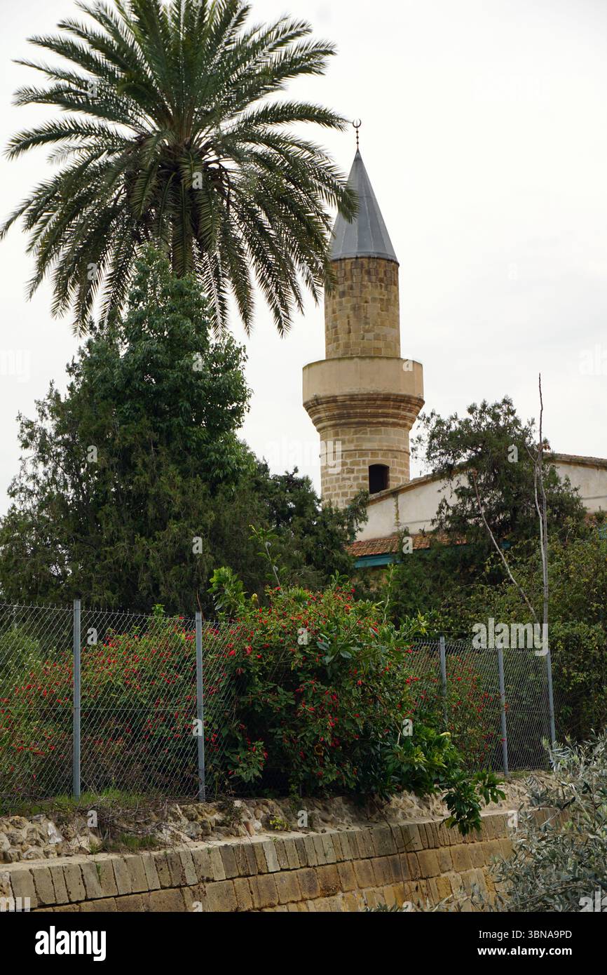 A tall, slender tower with a pointed roof and a small window, standing ...