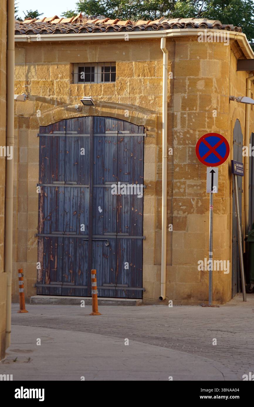A stone building with a curved corner and a tiled roof. The building's ...