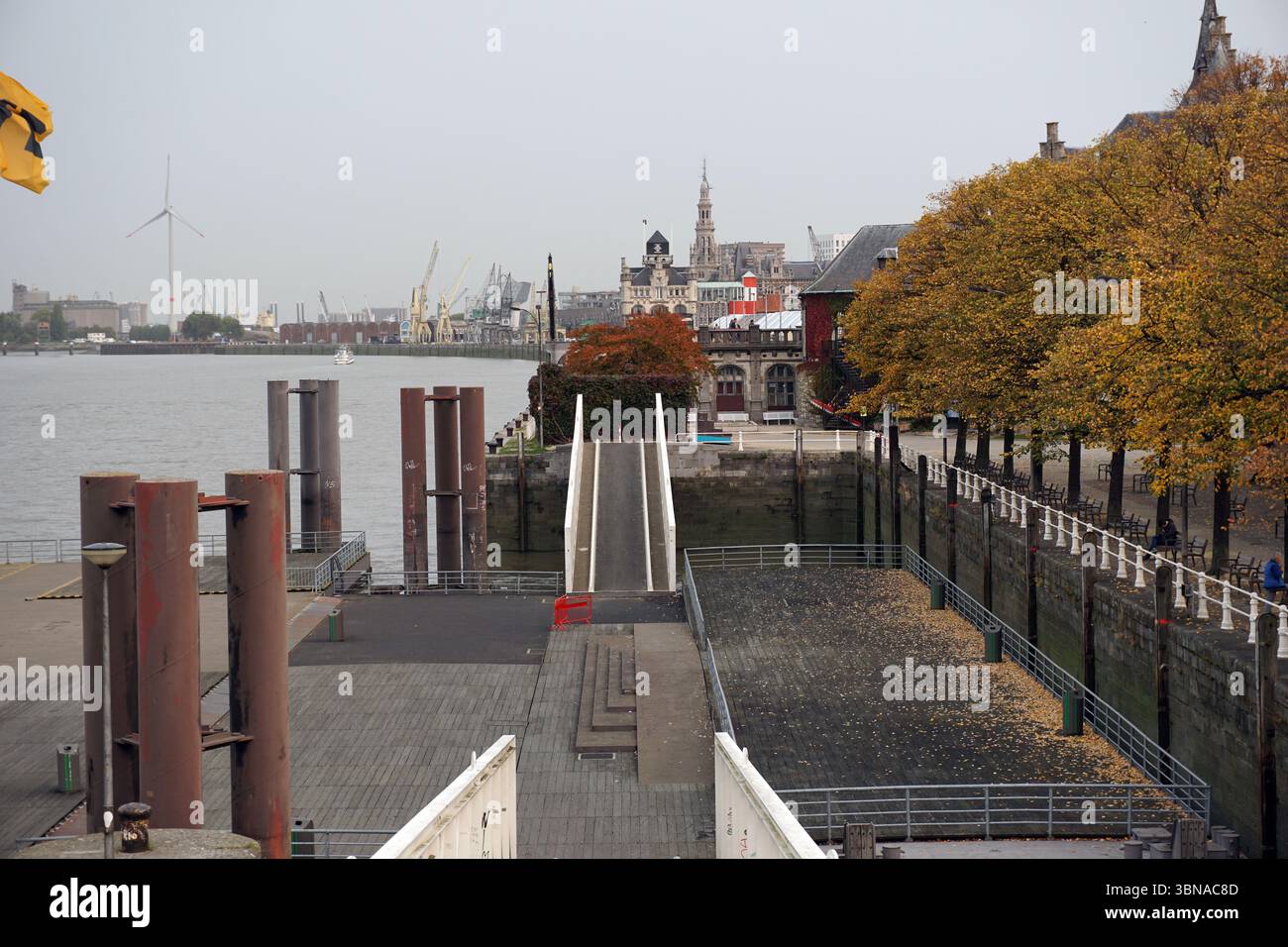 A serene harbor scene. A wooden walkway with a metal railing leads ...