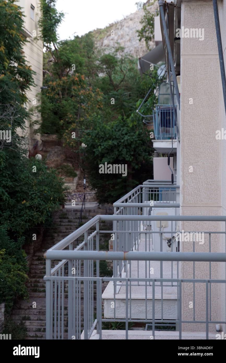 A balcony with a metal railing. The balcony is part of a multi-story ...