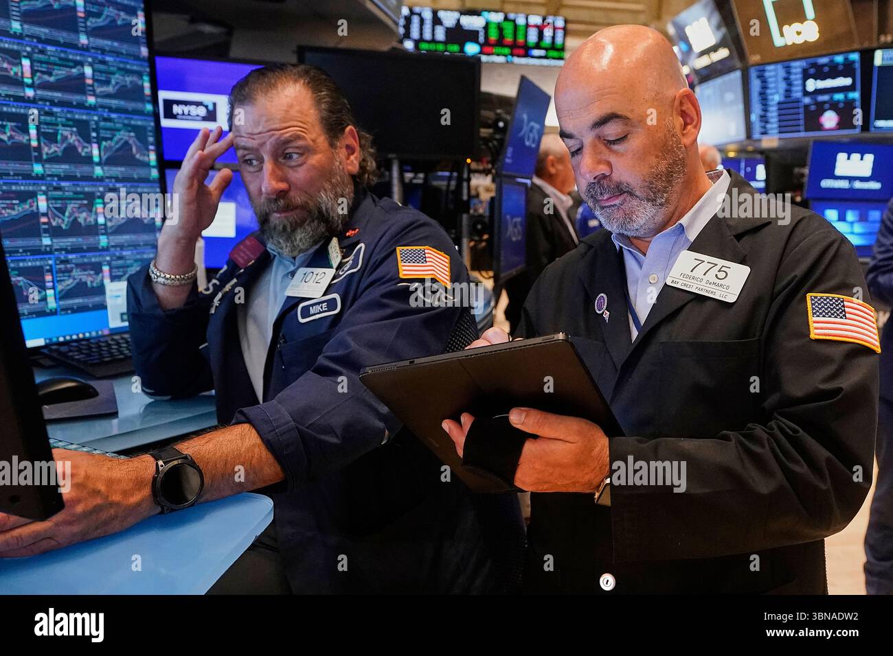 Specialist Michael Pistillo, left, and trader Fred DeMarco work on the ...