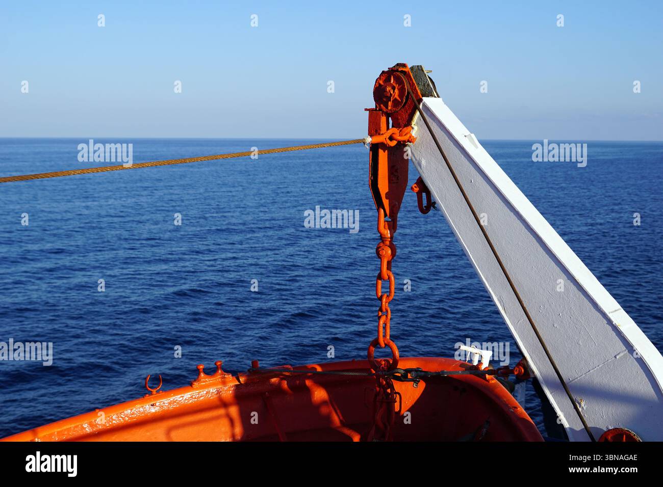 A section of a ship's deck, likely a lifeboat, with a bright orange ...