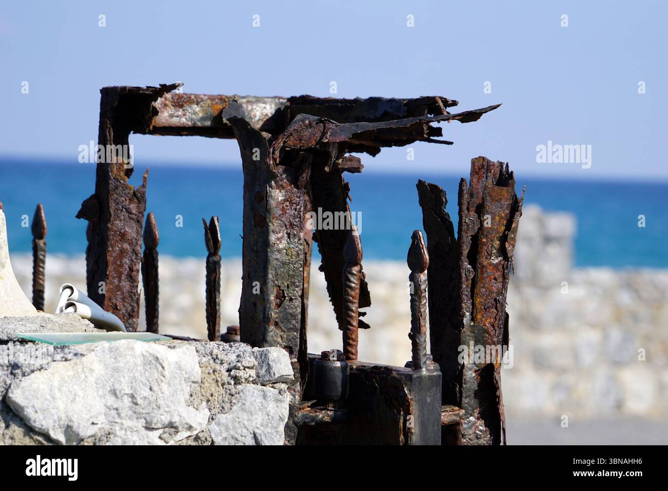 A rusted metal structure, possibly a remnant of a fence or gate. The ...