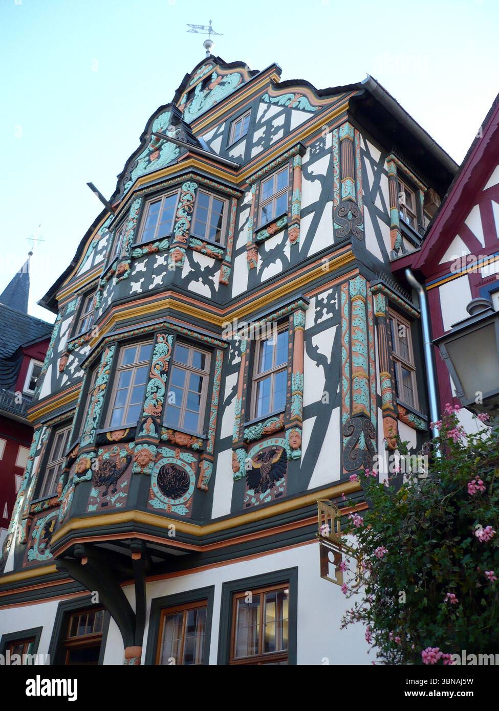 A three-story building with a half-timbered design, featuring a ...