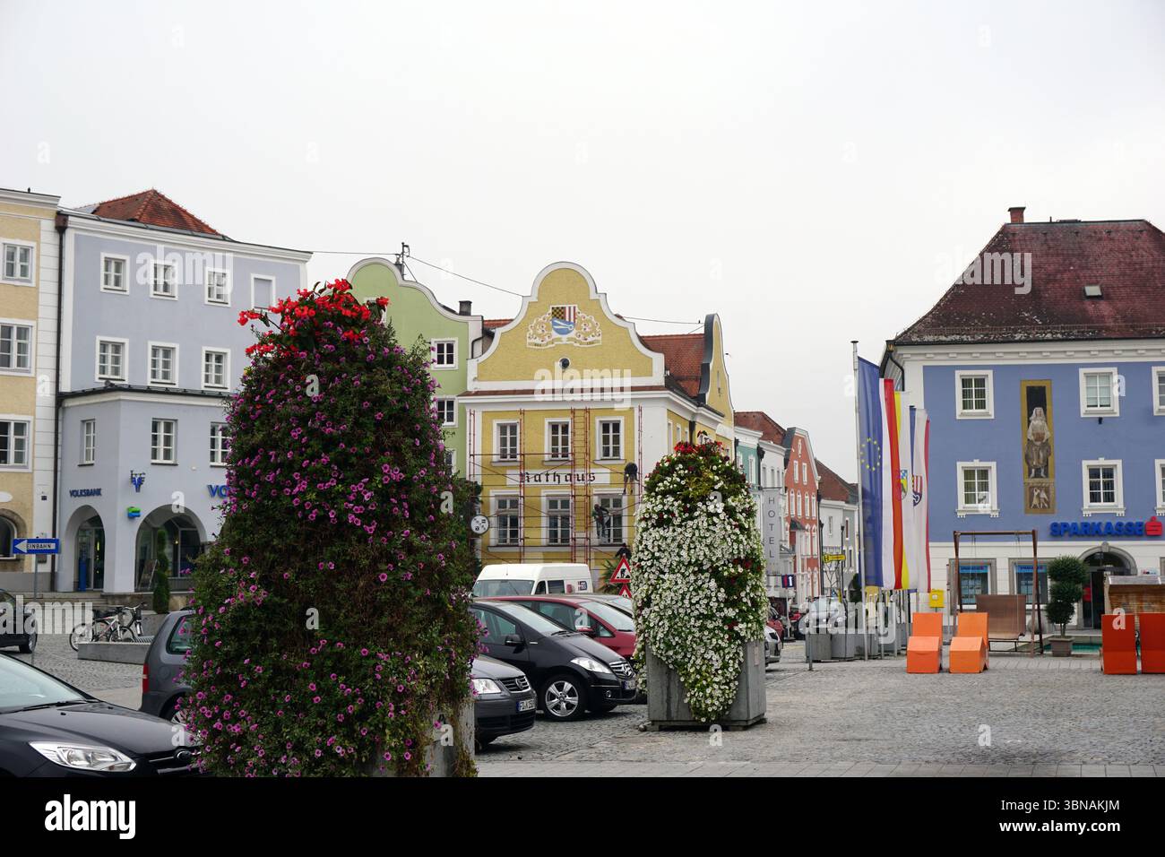 A vibrant square with a variety of colorful buildings, including a ...