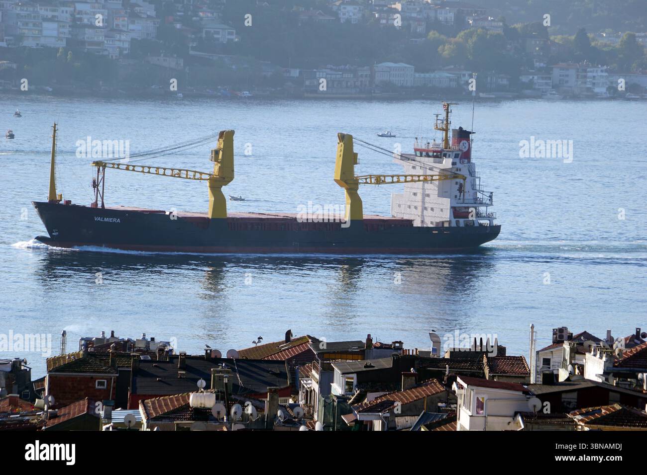 A large cargo ship named "VALMERA" sailing on a calm body of water. The ...