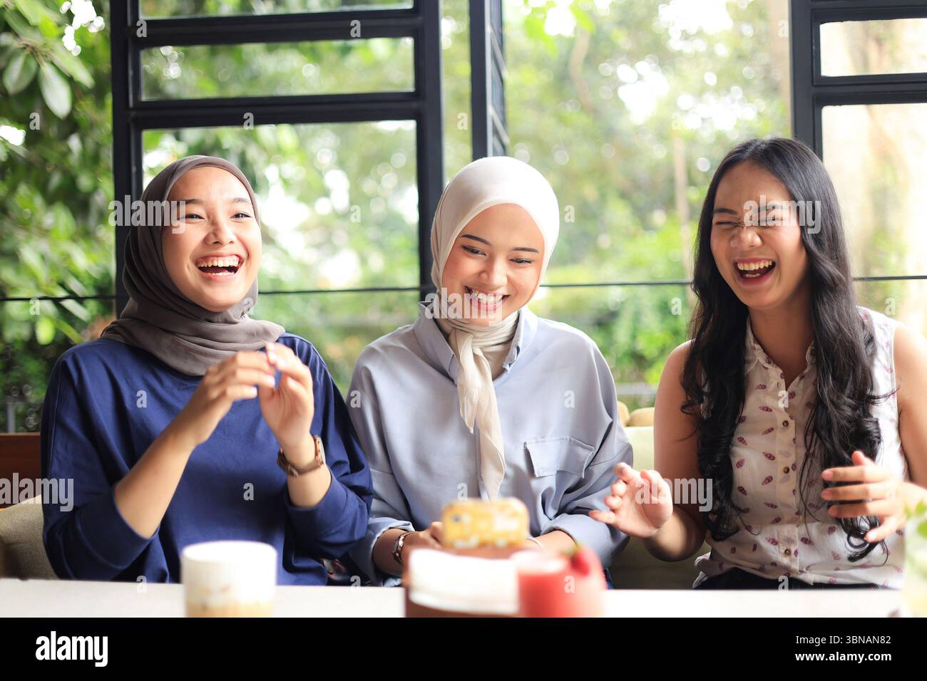 Three Asian Female Friends Happy Sitting in Cafe Next to Window ...