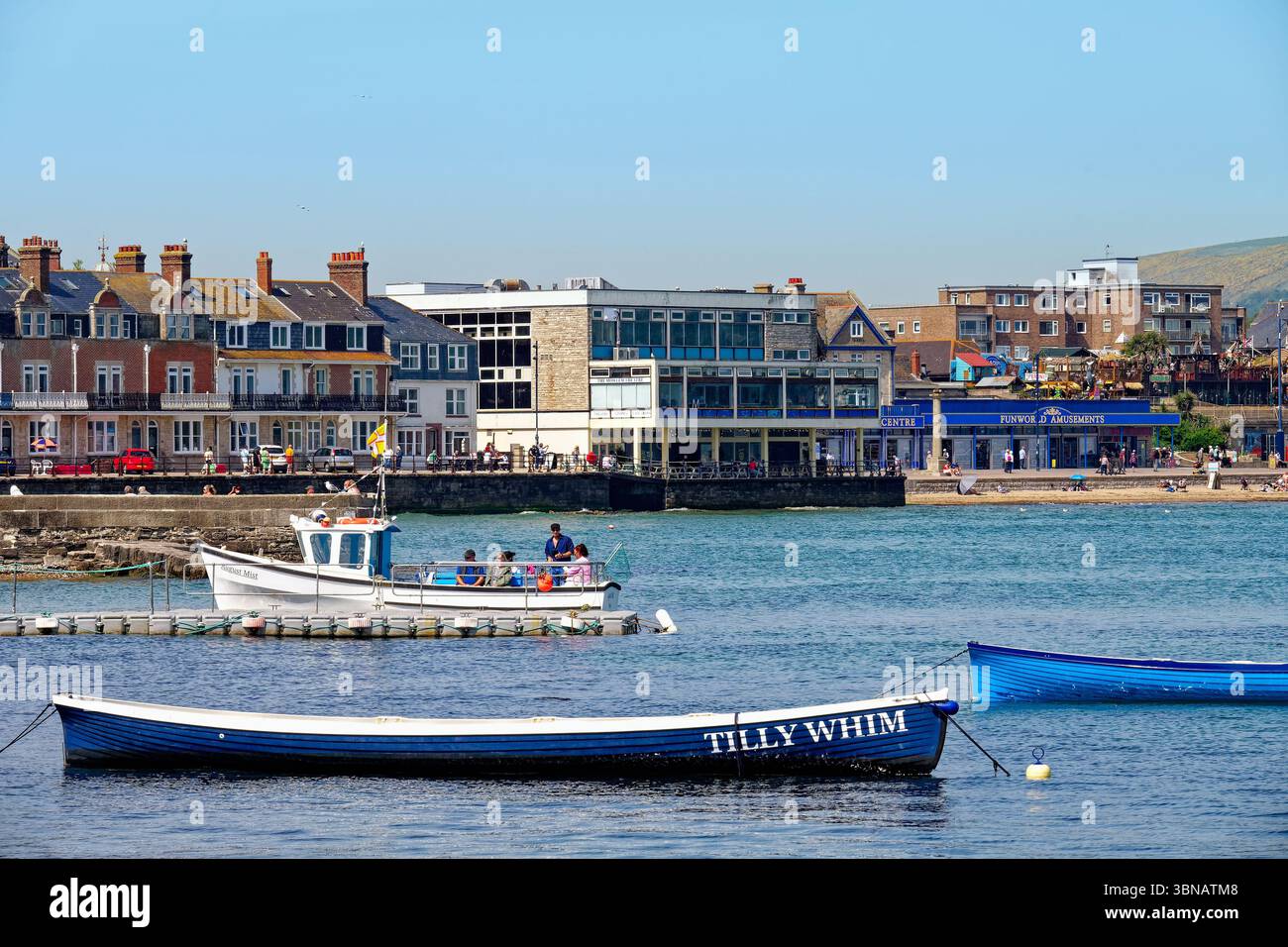 The view across Swanage bay, boats in foreground with the towns ...