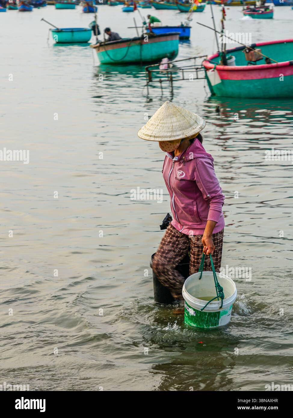 Mui Ne, Vietnam- March 22, 2025: A local fisherwoman in Mui Ne, returns ...