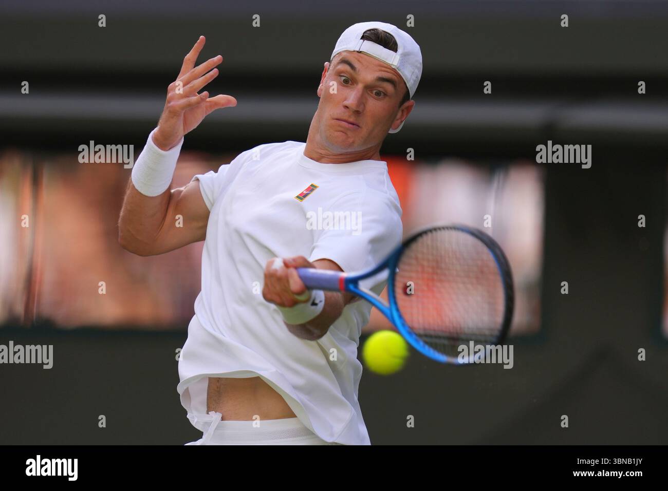 Jack Draper of Britain returns the ball to Sebastian Baez of Argentina ...