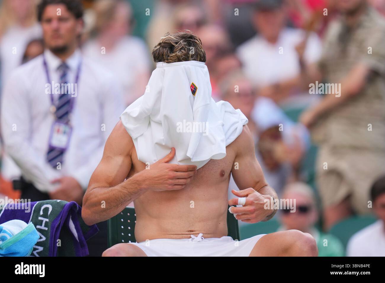 Jack Draper of Britain puts a news shirt on during the first round men ...