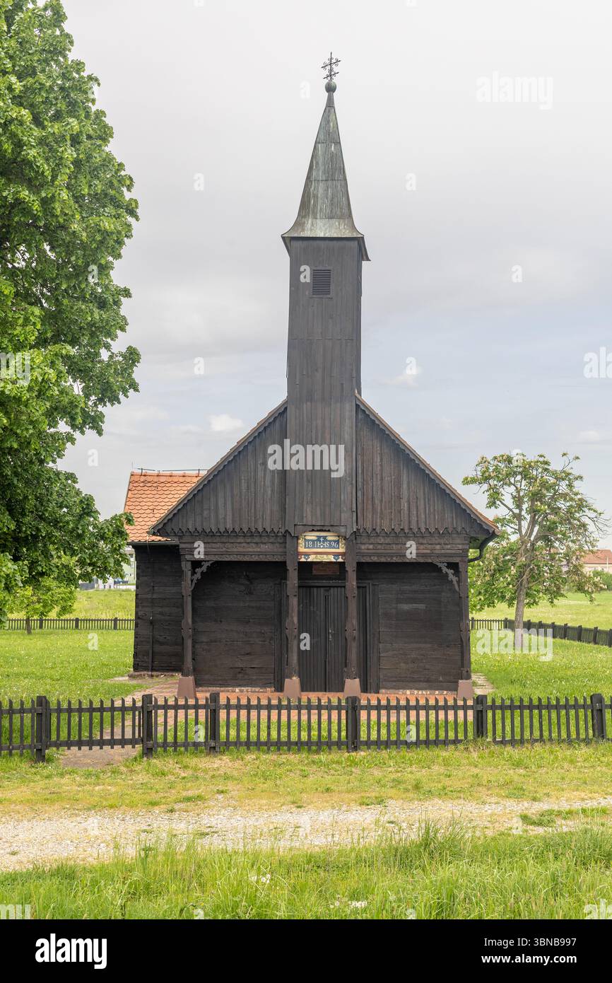 A quaint historic wooden chapel featuring a red tiled roof under a ...