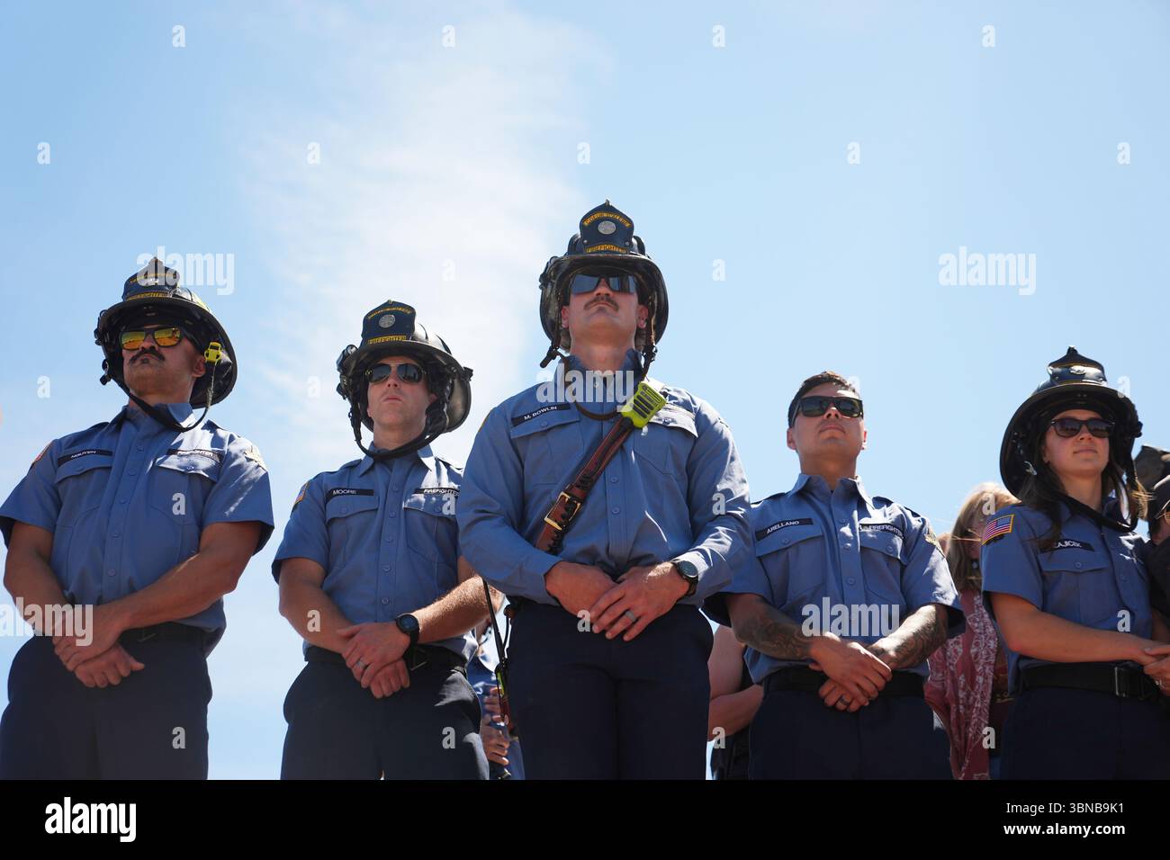 Members of the Coeur d'Alene Fire Dept. stand to honor the firefighters ...