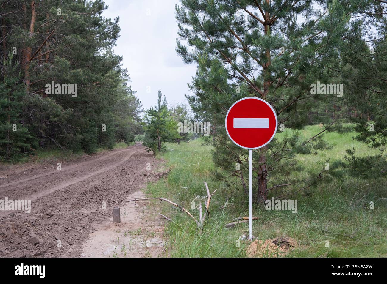 No entry sign on dirt road in forest. Conceptual photo Stock Photo - Alamy
