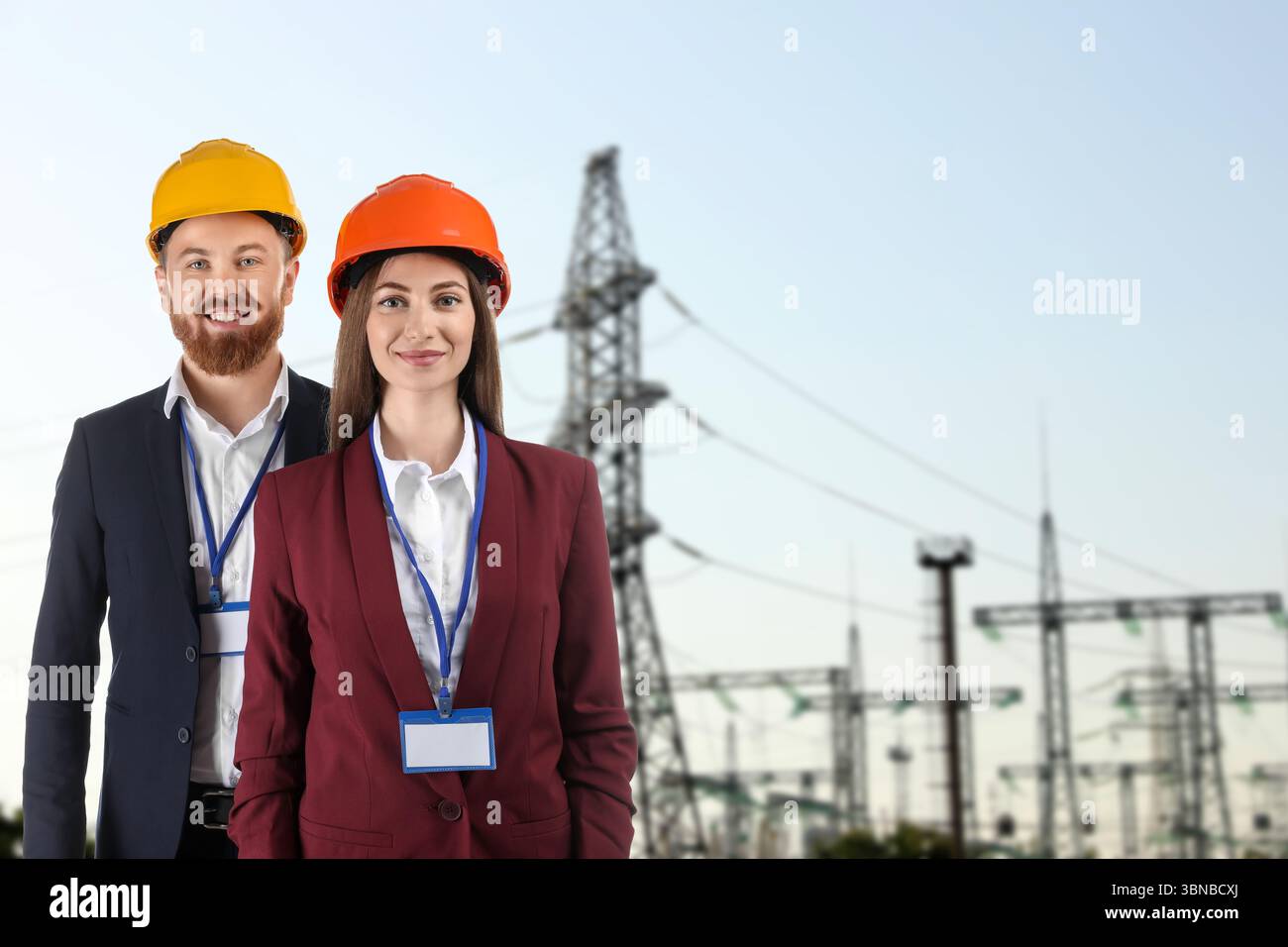 Power engineers in hard hats against electrical substation Stock Photo ...