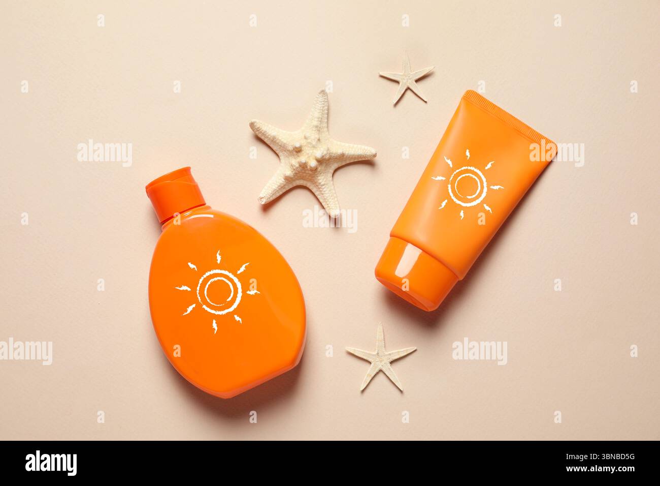 Sunscreen products and sea stars on beige background, top view. Bottle ...