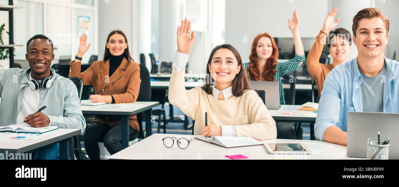 Portrait of diverse students raising hands at classroom Stock Photo - Alamy