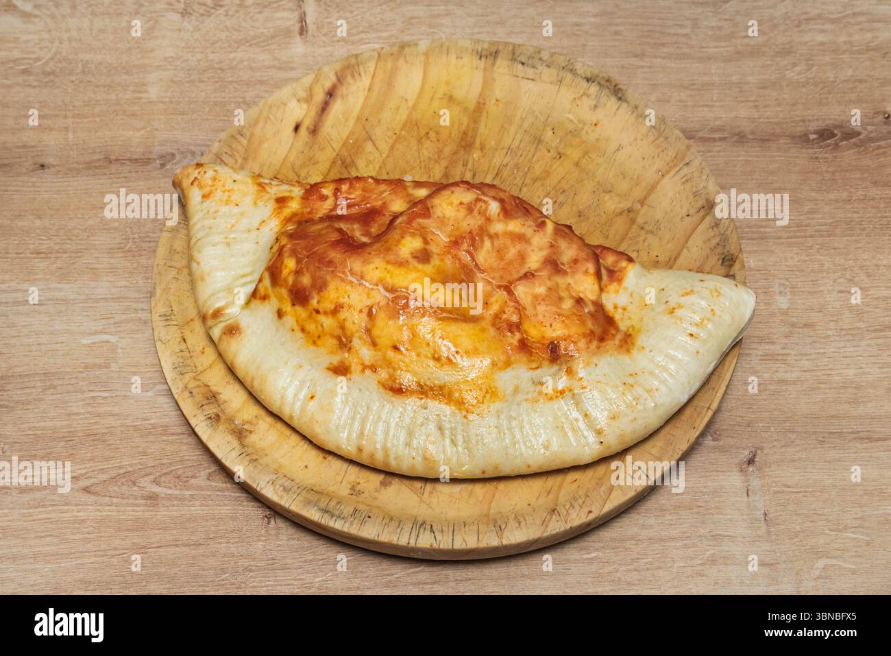 The calzone is essentially a pizza folded in half Stock Photo - Alamy