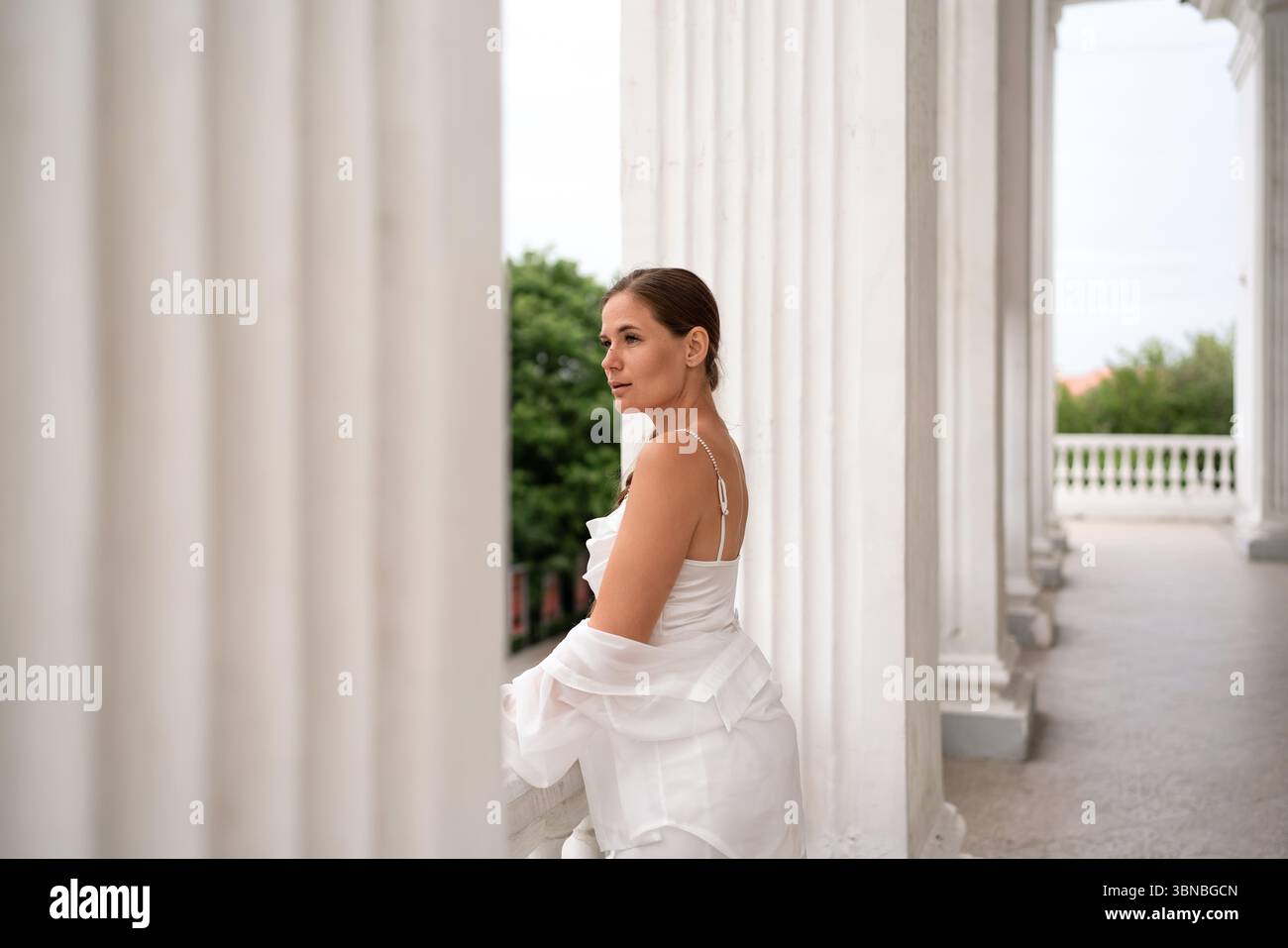 Woman Columns Balcony: Lady in white looks outward from a columned ...