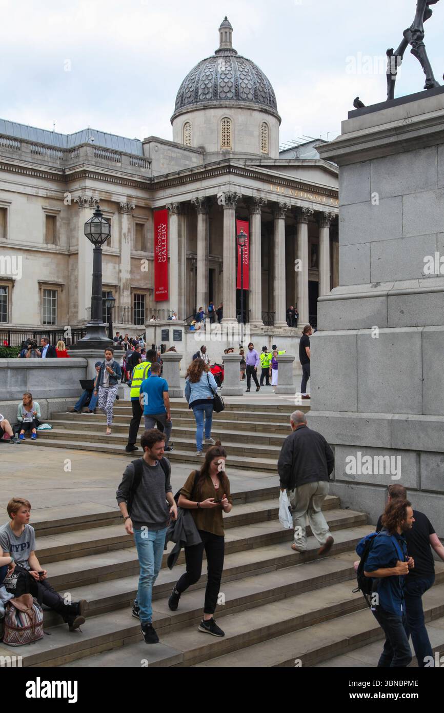 People walking up the steps outside the National Gallery in London ...