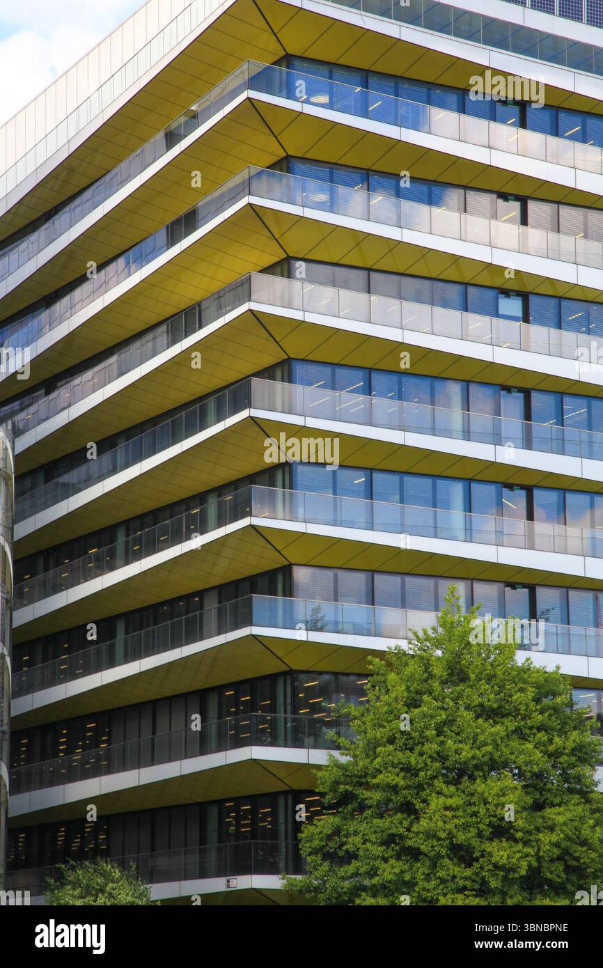 Modern office building with geometric glass balconies and yellow ...