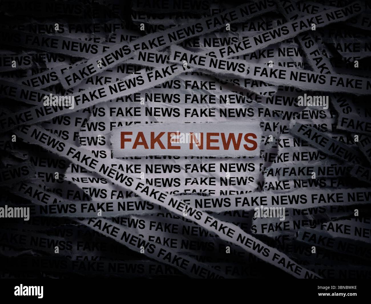 Strips of newspaper with the words Fake News typed on them. Close up ...