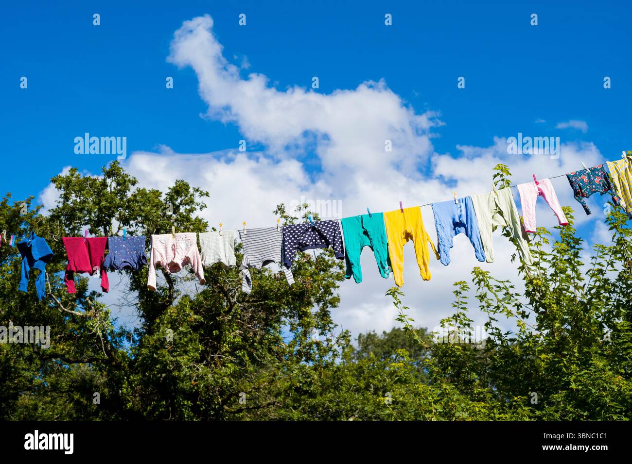 Clean clothes pegged on a traditional washing line in England, UK Stock ...
