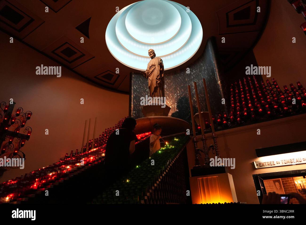 A girl lights a candle at Saint Joseph's Oratory of Mount Royal in ...