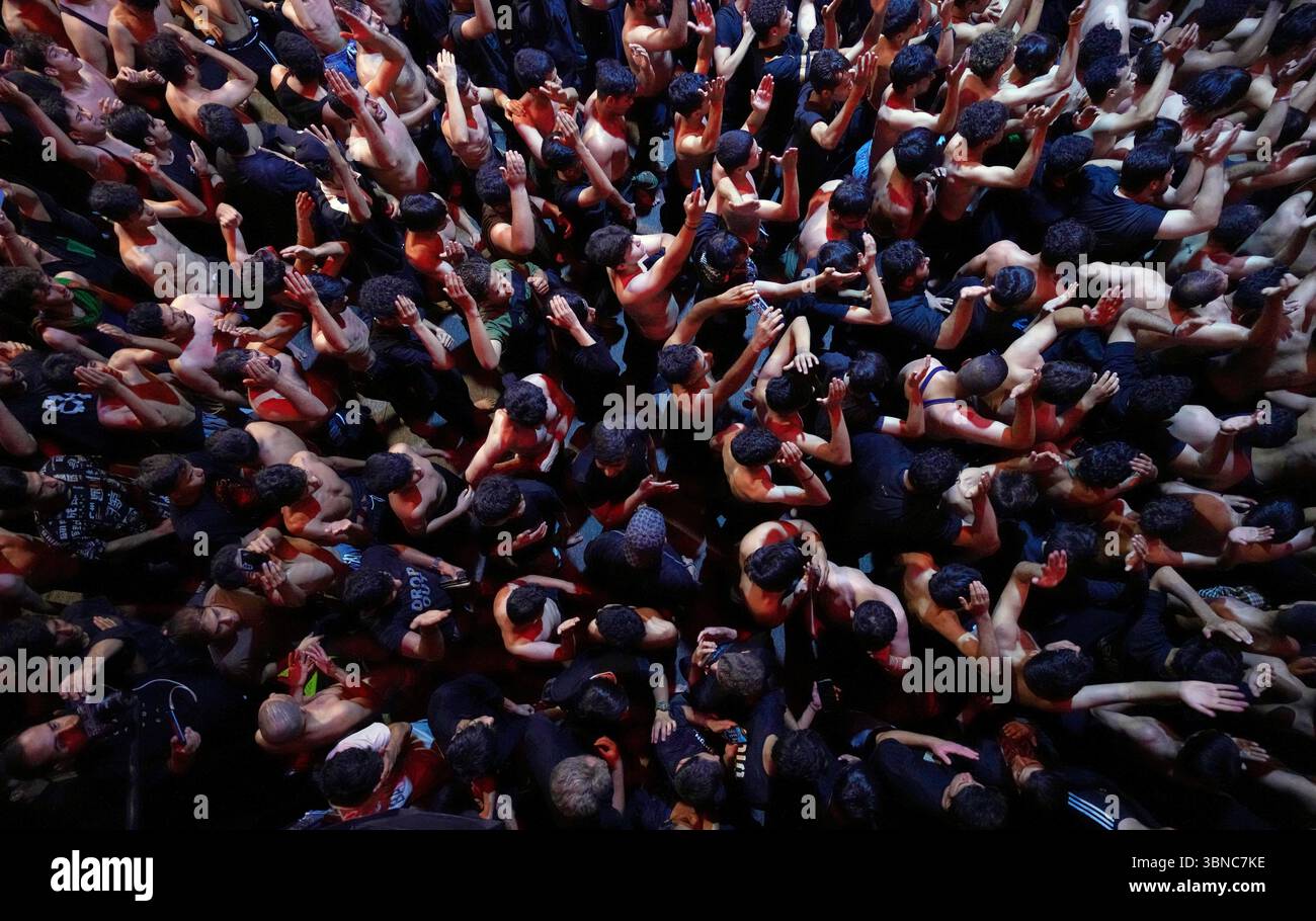 Shiite faithful Muslims beat their chests as a sign of grief for Imam ...