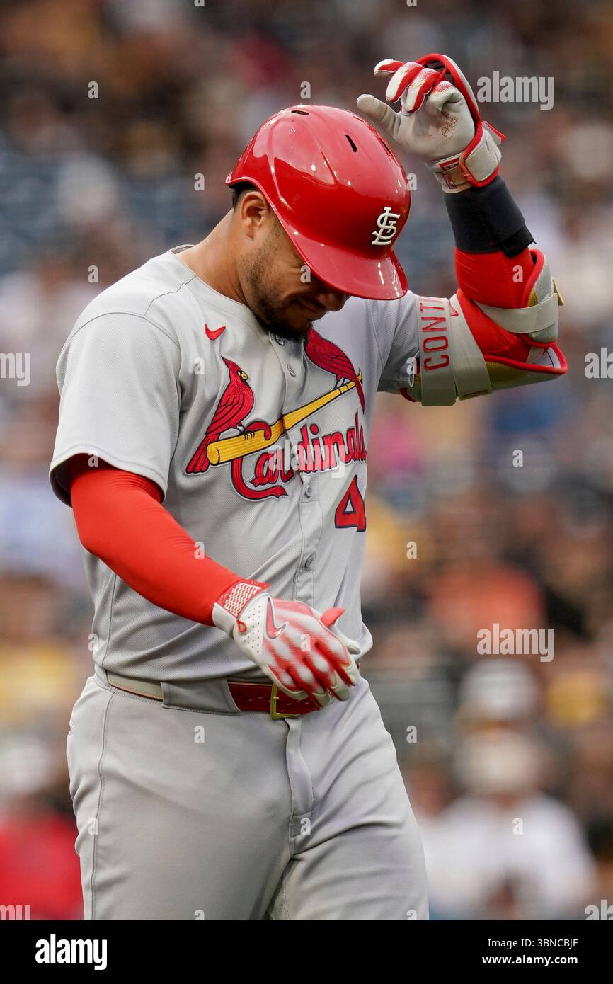 St. Louis Cardinals' Willson Contreras reacts after getting hit by a ...