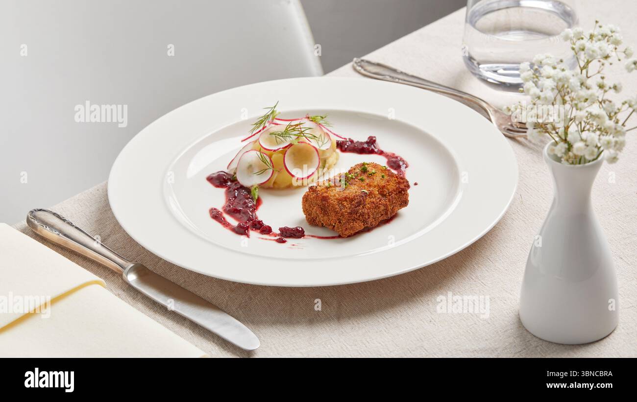 Plant-based schnitzel with classic potato salad – served as a festive ...