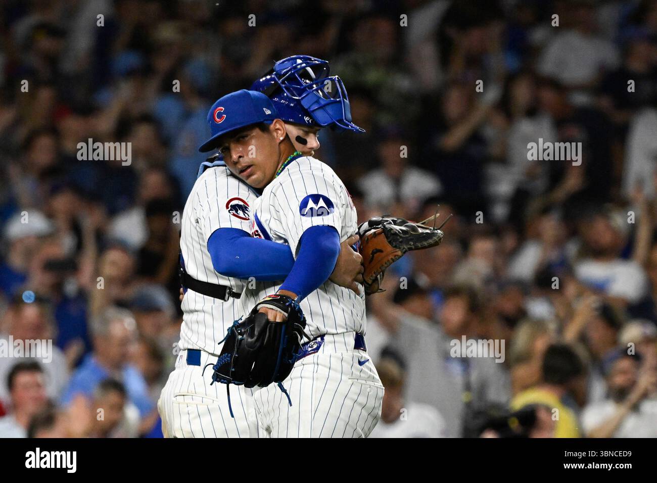 Chicago Cubs pitcher Daniel Palencia hugs catcher Carson Kelly, left ...