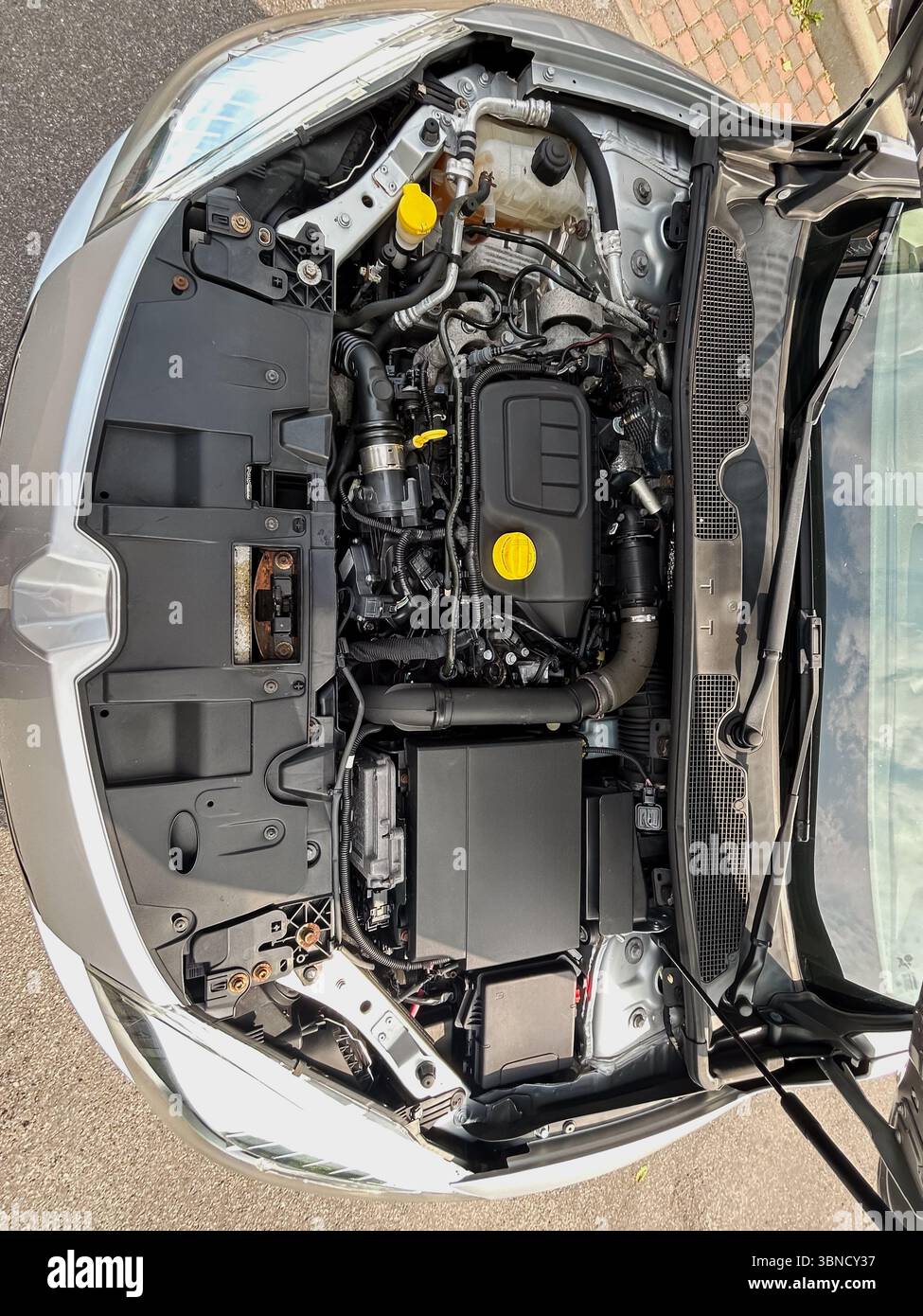 Examine the intricate design of this cars engine bay, showcasing ...