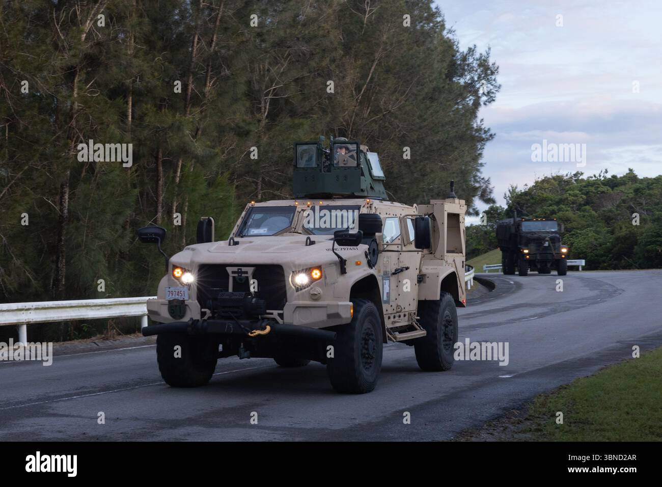 A U.S. Marine Corps Joint Light Tactical Vehicle leads a simulated ...