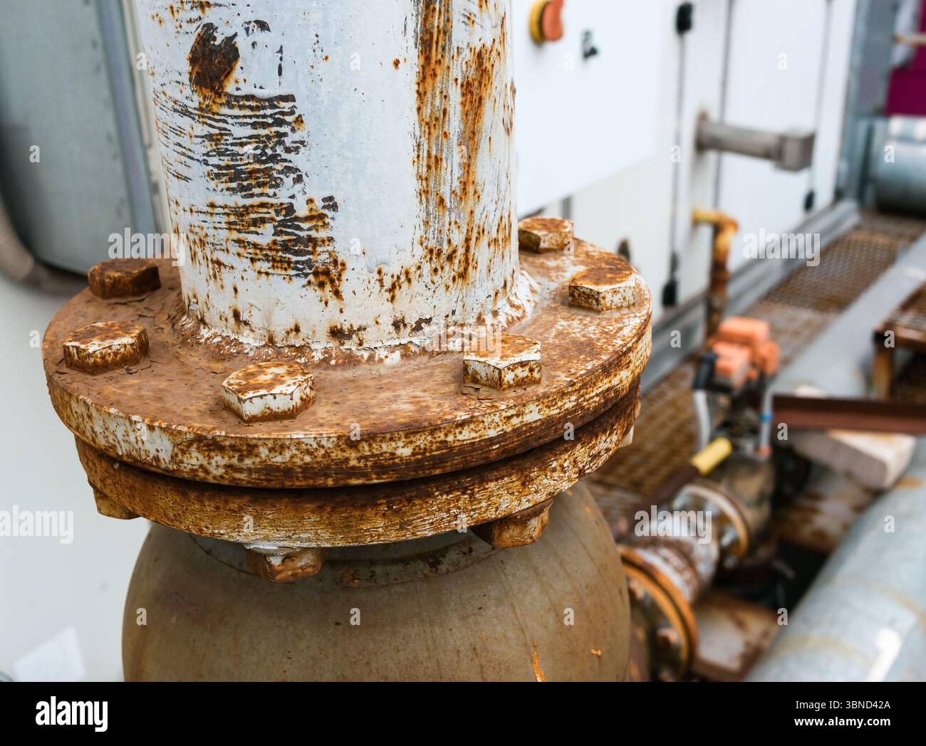 Close-up of a rusted industrial pipeline flange with corroded bolts and ...
