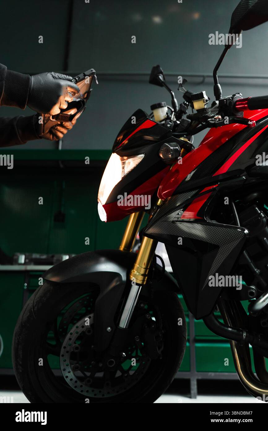 Mechanic performing system diagnostics via tablet. Motorcycle system ...