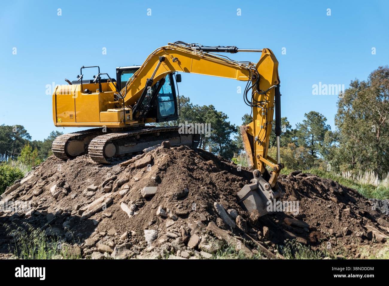 Engineering in action. The backhoe dominates the pile of gravel Stock ...